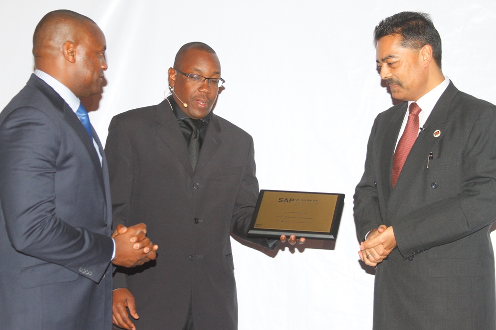 Bidco_CEO_Vimal_Shah_right_being_presented_by_an_award_by_SAP_East ...